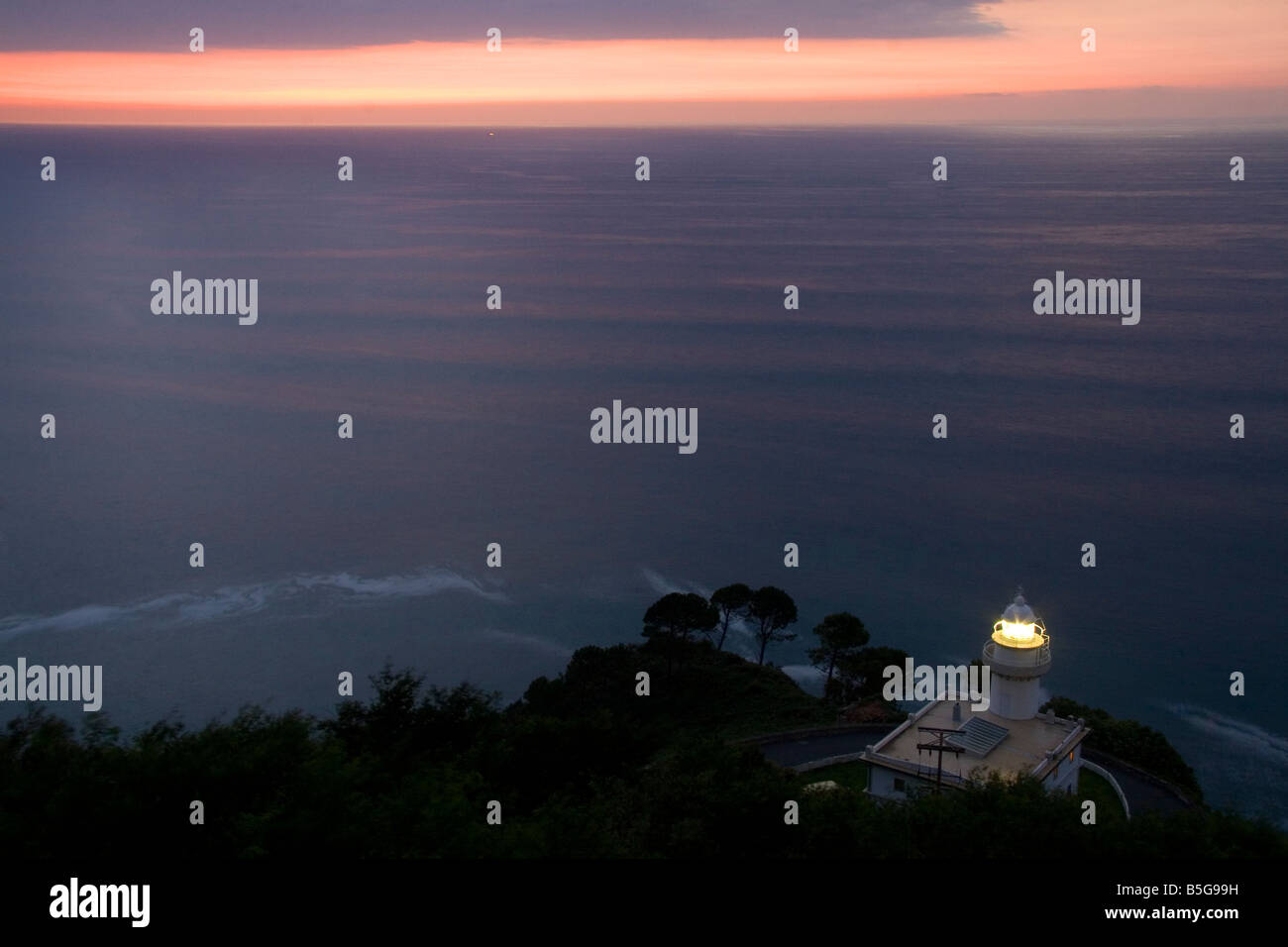 Monte Igueldo Lighthouse at night in La Concha Bay near the city of ...