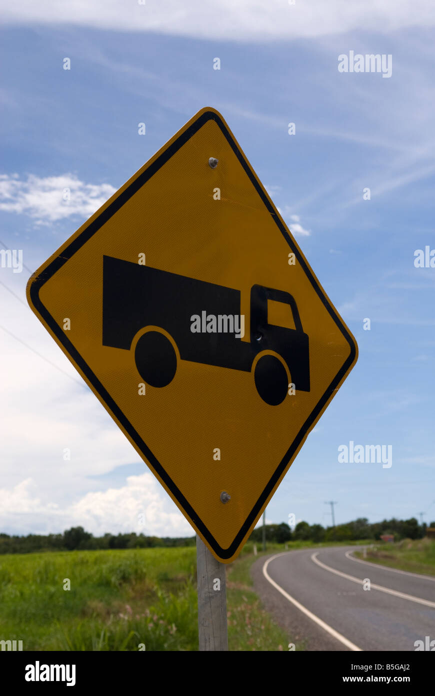 A yellow warning sign alerting drivers to the presence of lorries in ...