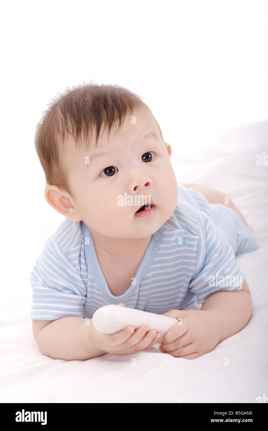 Baby boy lying on front, holding a boy Stock Photo - Alamy