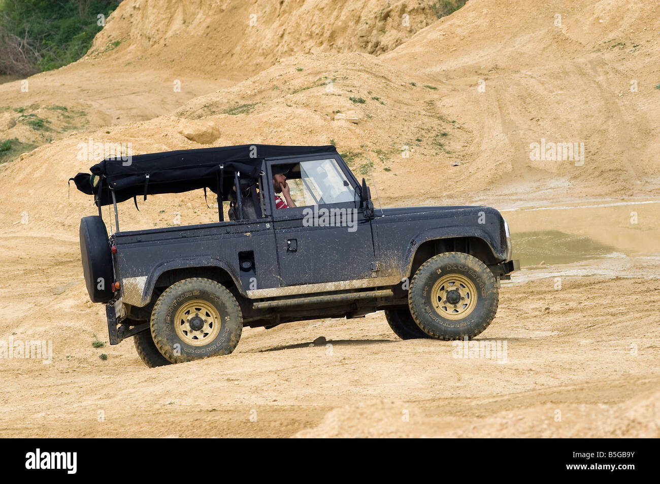 Land Rover defender driving off road in the UK Stock Photo - Alamy