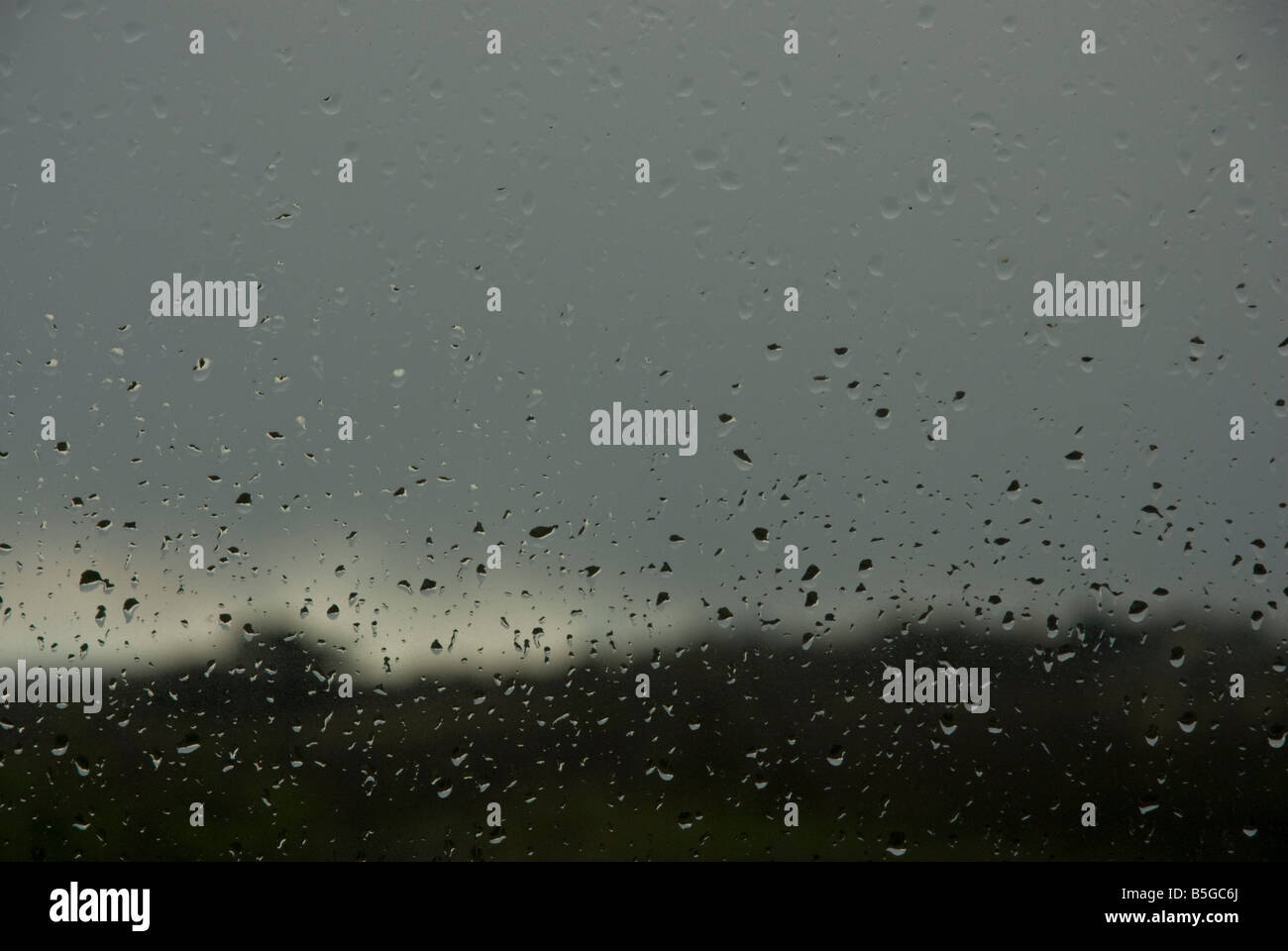Heavy raindrops on window pane Stock Photo - Alamy