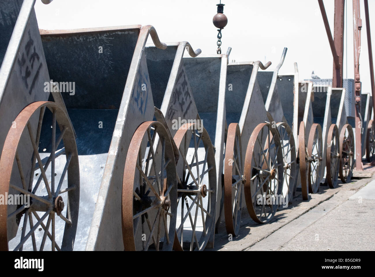Row of wheelbarrows used for transporting fish in the harbor of ...