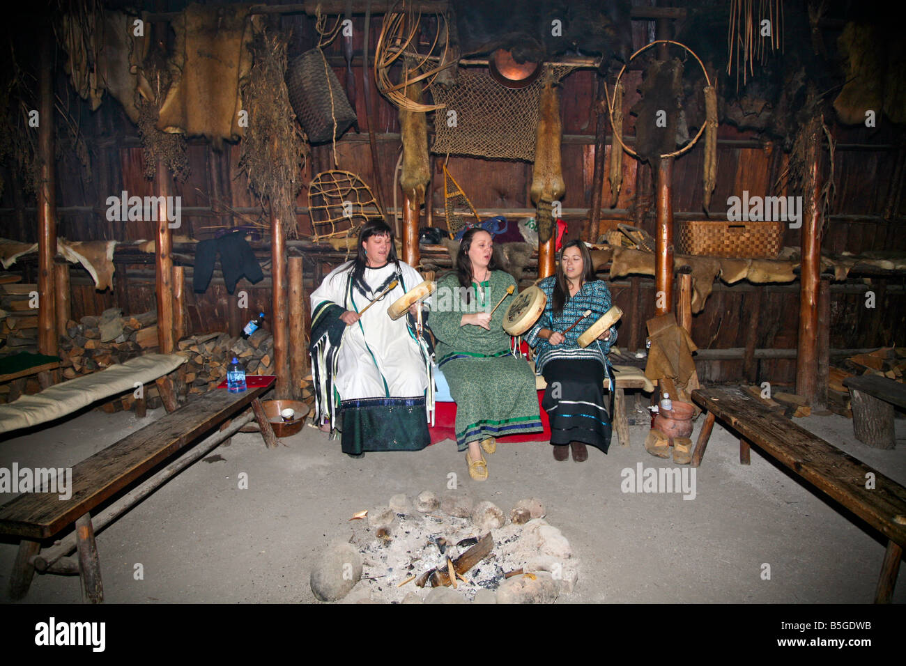 Three women singing on camp fire in long-house at Huron-Jesuit ...