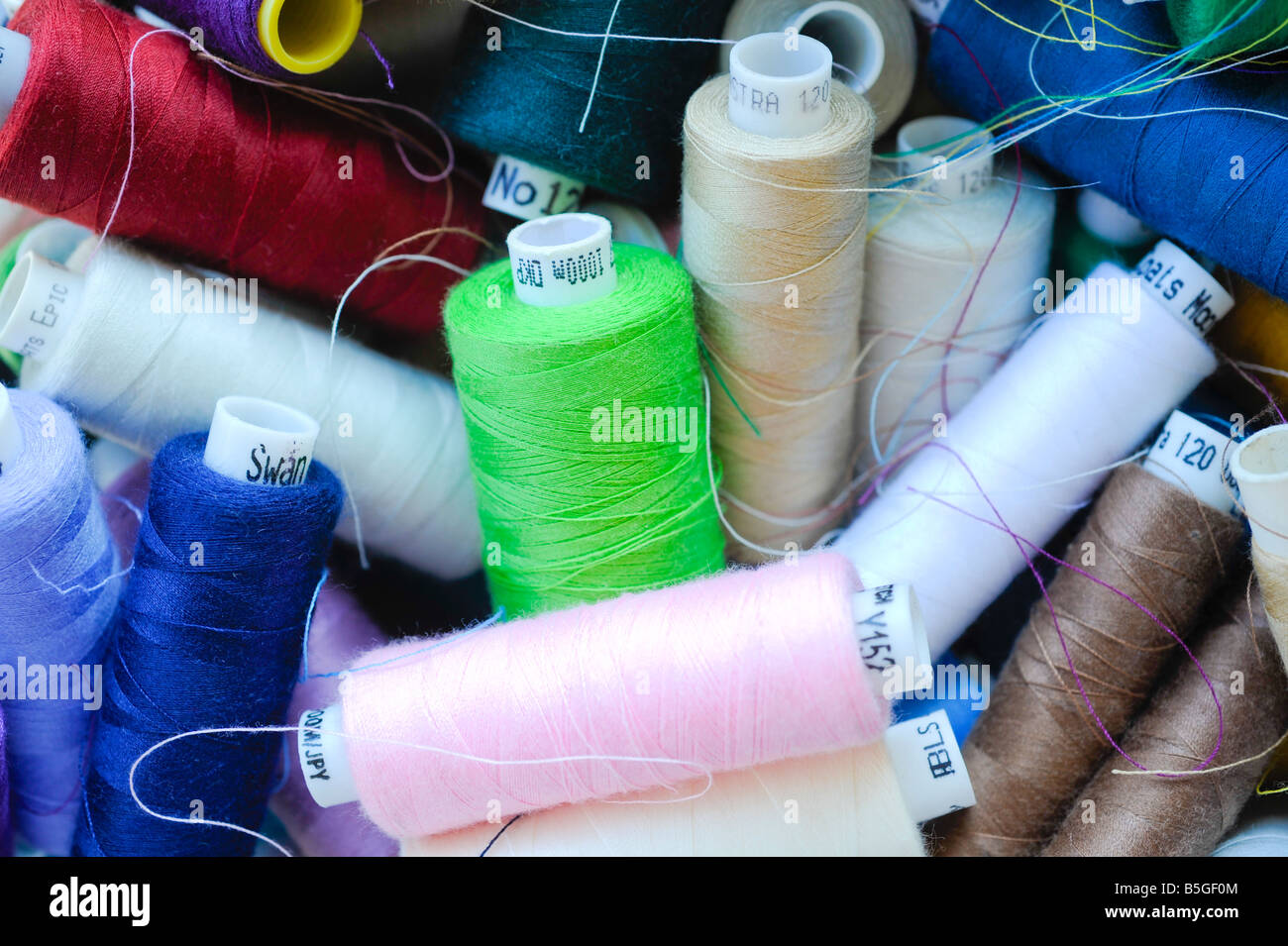 Brightly coloured cottons reels on sewing basket Stock Photo - Alamy