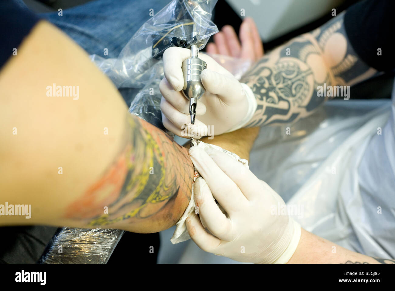 Man having his arm tattooed Stock Photo - Alamy