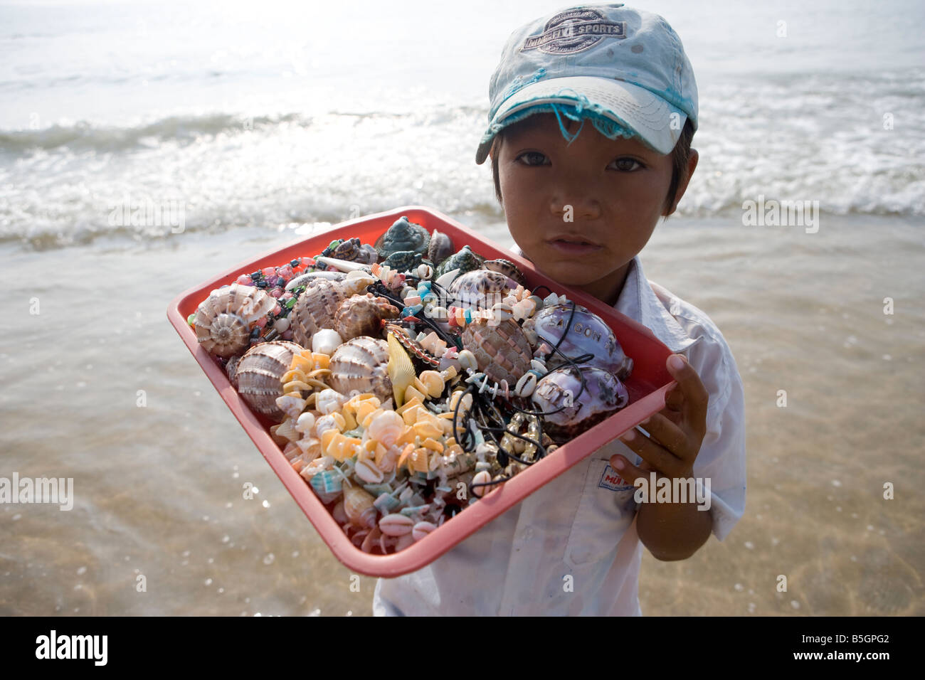 Young boy selling shells on the beach at Mui Ne, Vietnam Stock Photo ...