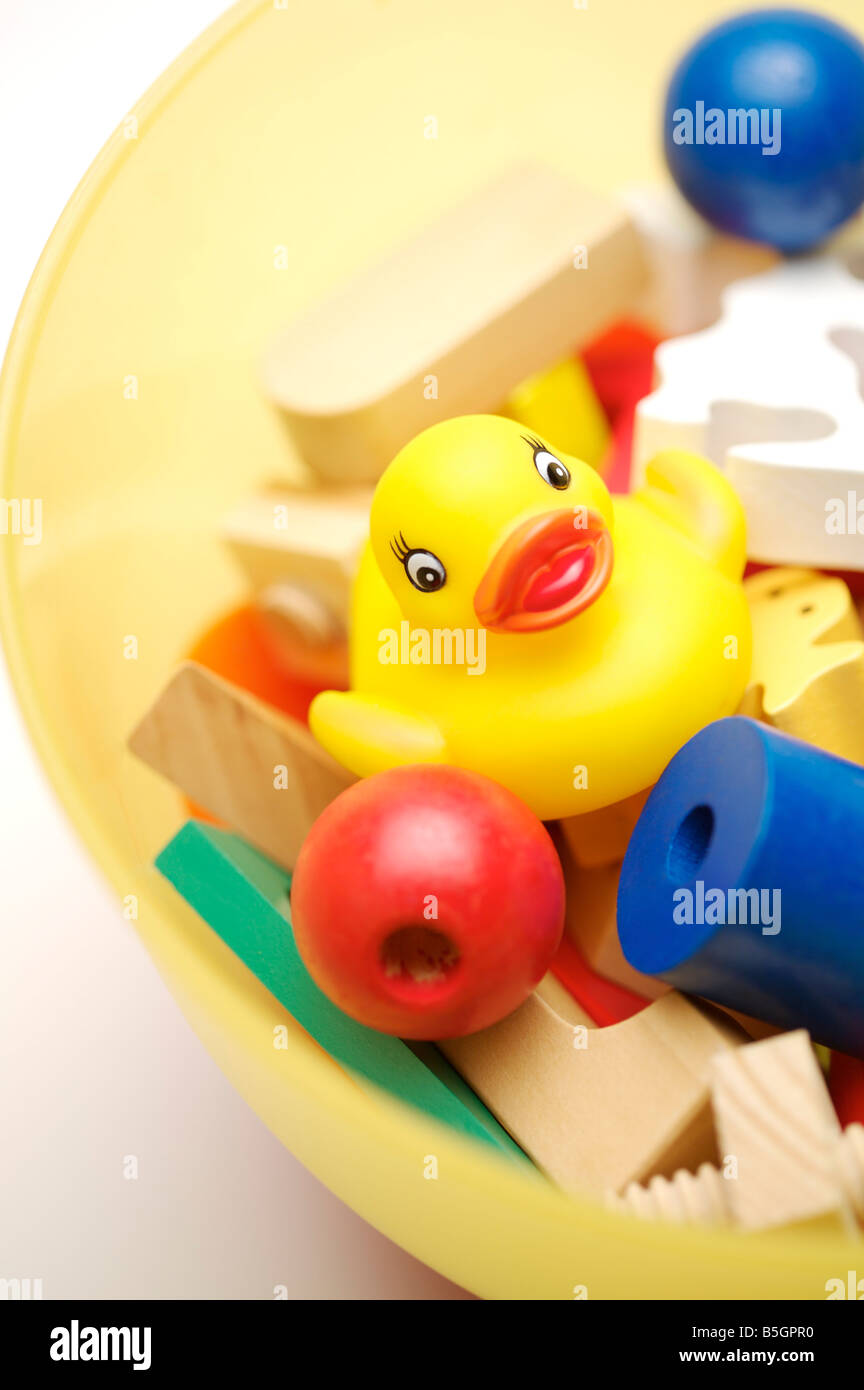 Yellow rubber duck and wooden toy blocks, in a plastic bowl Stock Photo ...