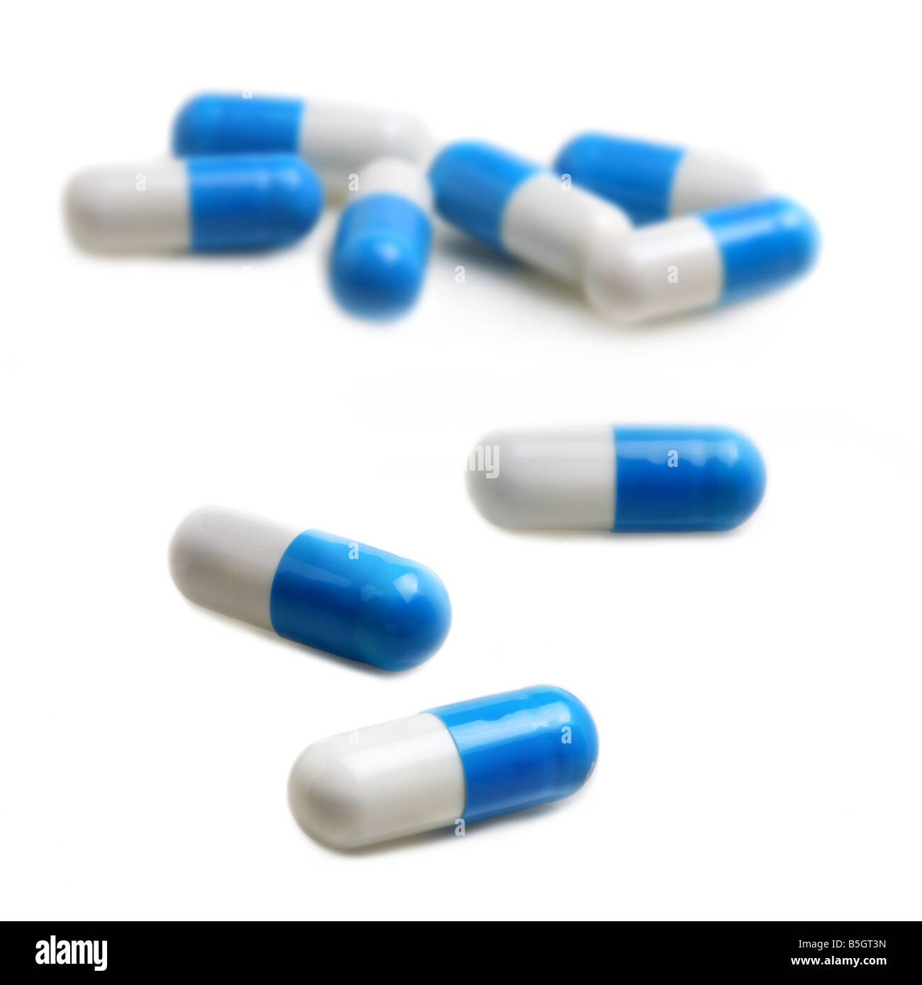 blue white capsules isolated on white Stock Photo - Alamy