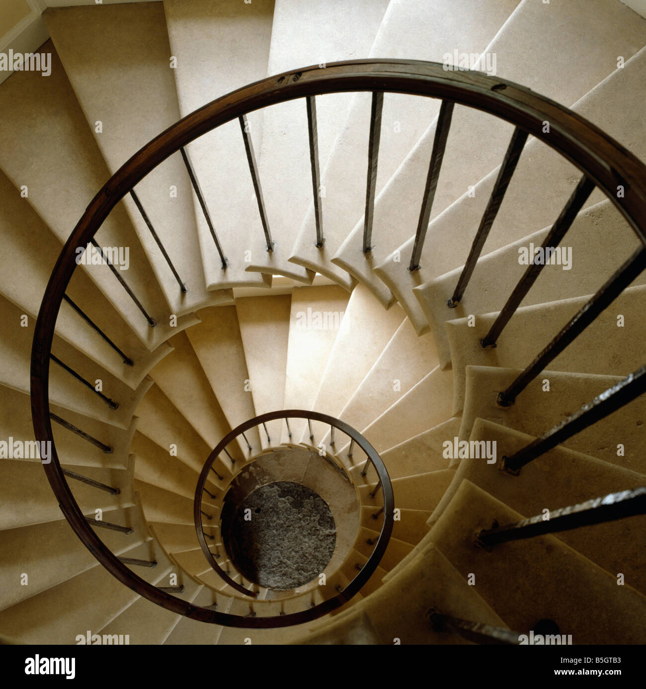 Birdseye view of stone spiral staircase with metal banisters Stock ...