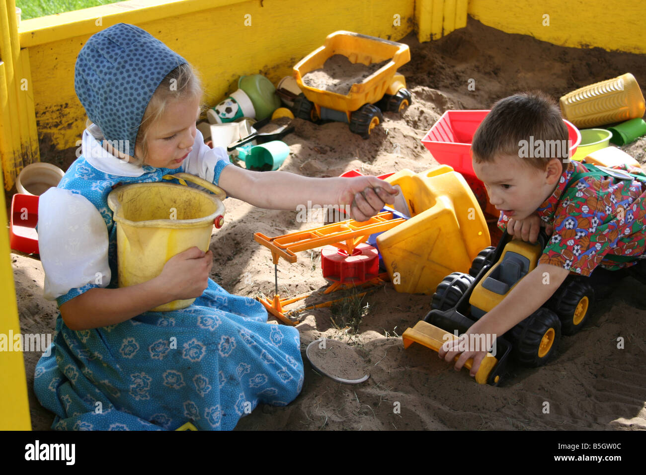 Hutterite preschool children playing in the sandbo Stock Photo - Alamy