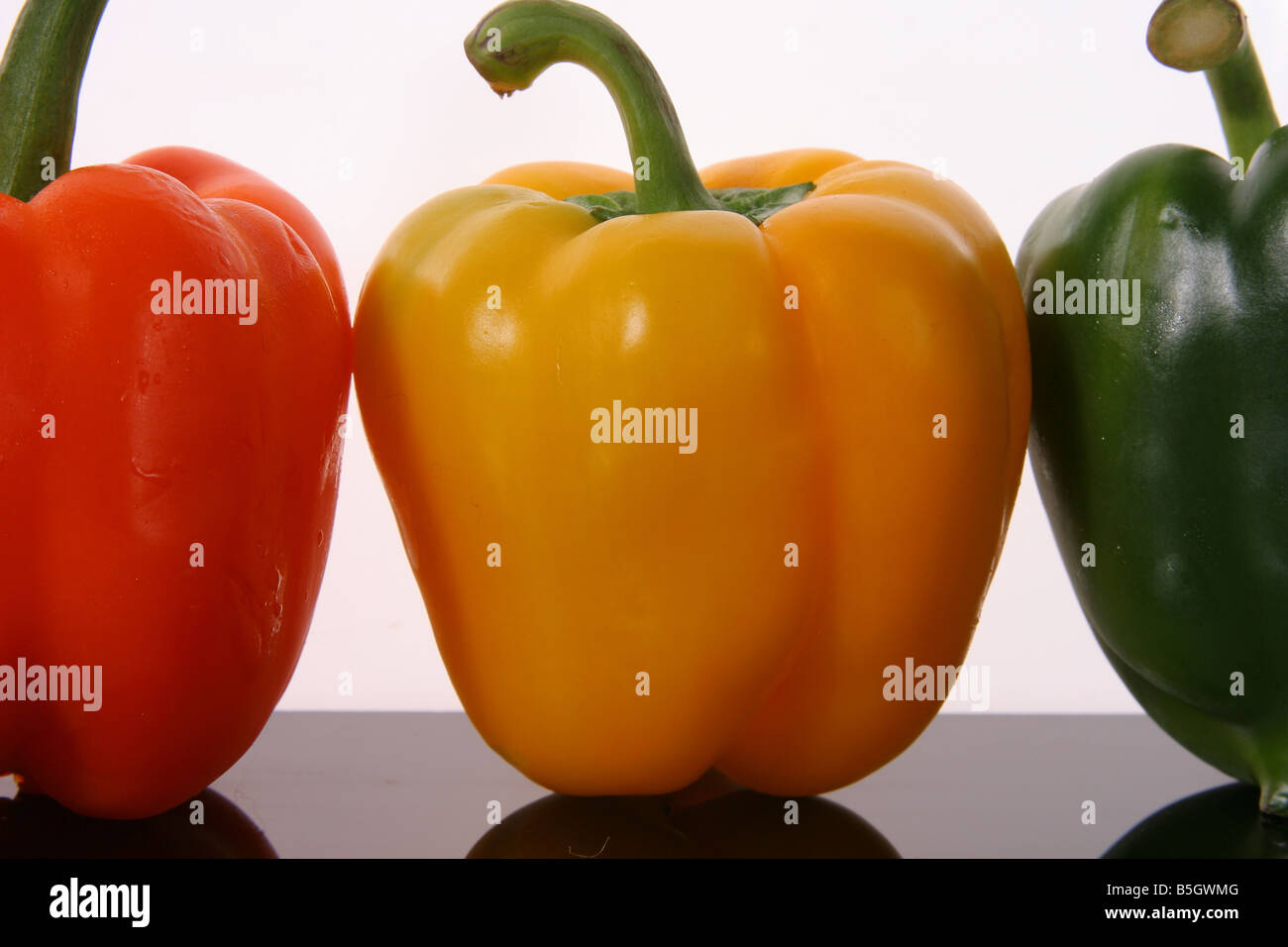 Various colored capsicum (bell peppers) close up Stock Photo - Alamy