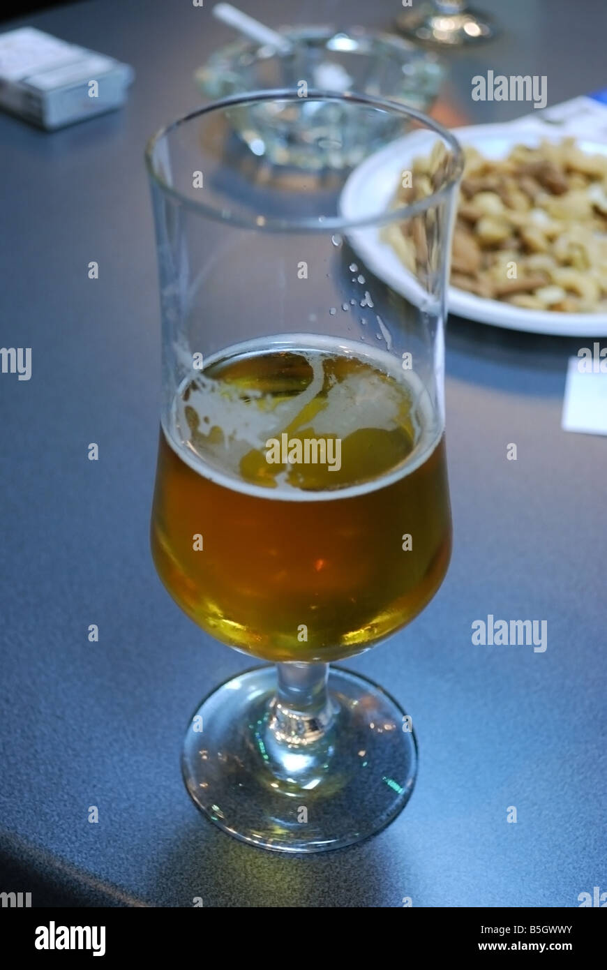 glass of beer on an office table Stock Photo - Alamy