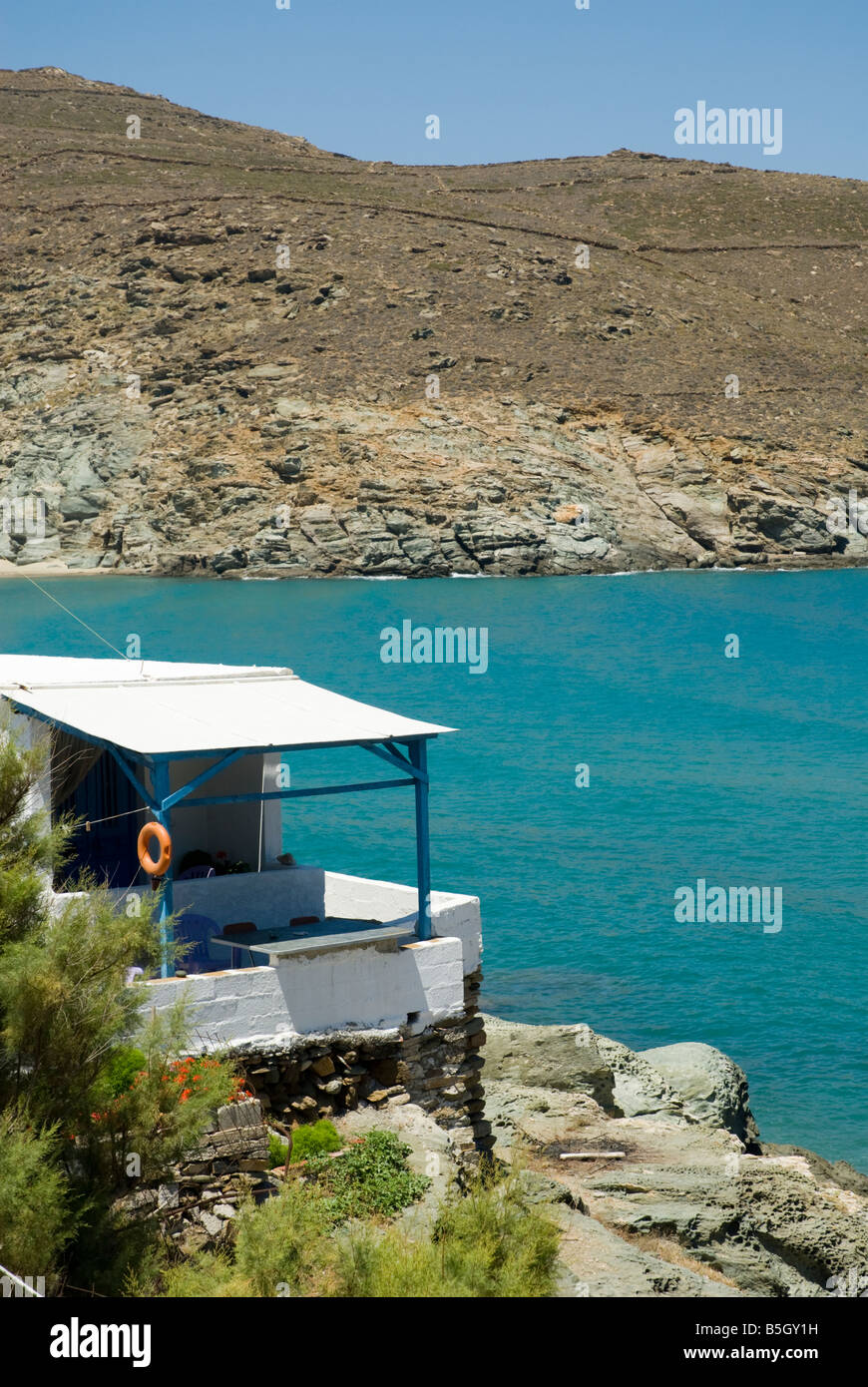 A cliffside beach hut overlooking the Aegean Sea at Kolimbithra Tinos ...