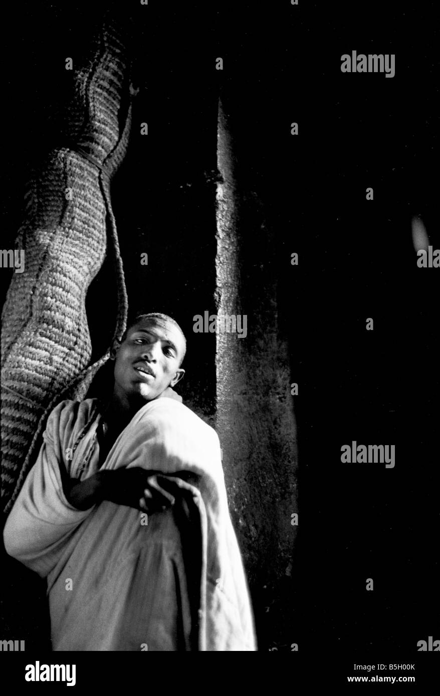 An Ethiopian Orthodox monk wearing traditional robes at Lalibela ...