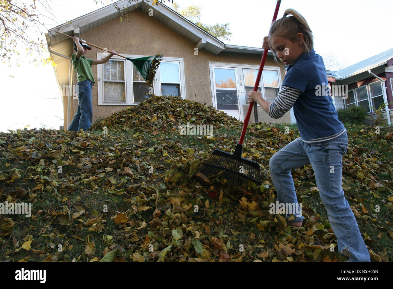 Children rake leaves house High Resolution Stock Photography and Images ...