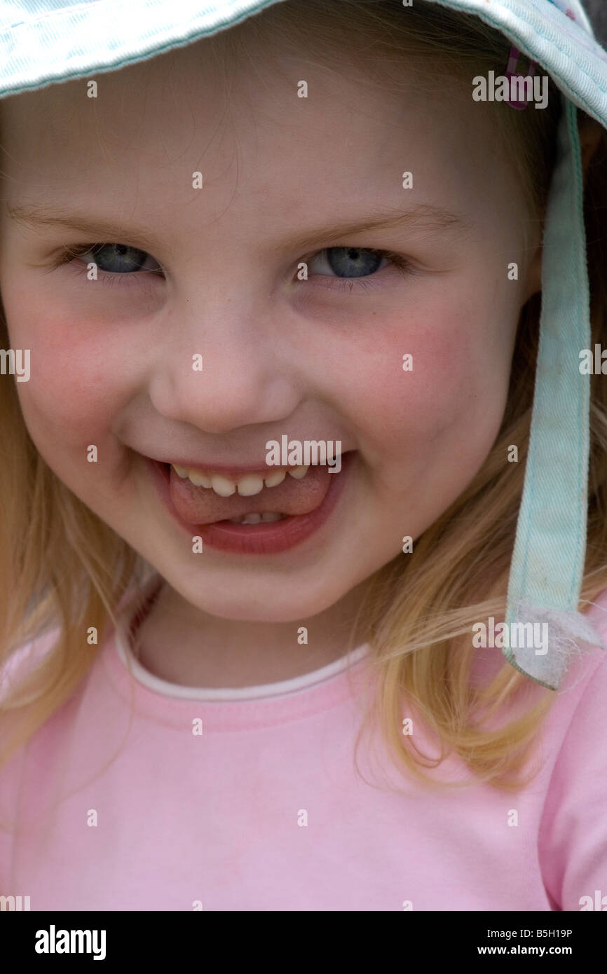 Young girl with a cheeky smile Stock Photo - Alamy