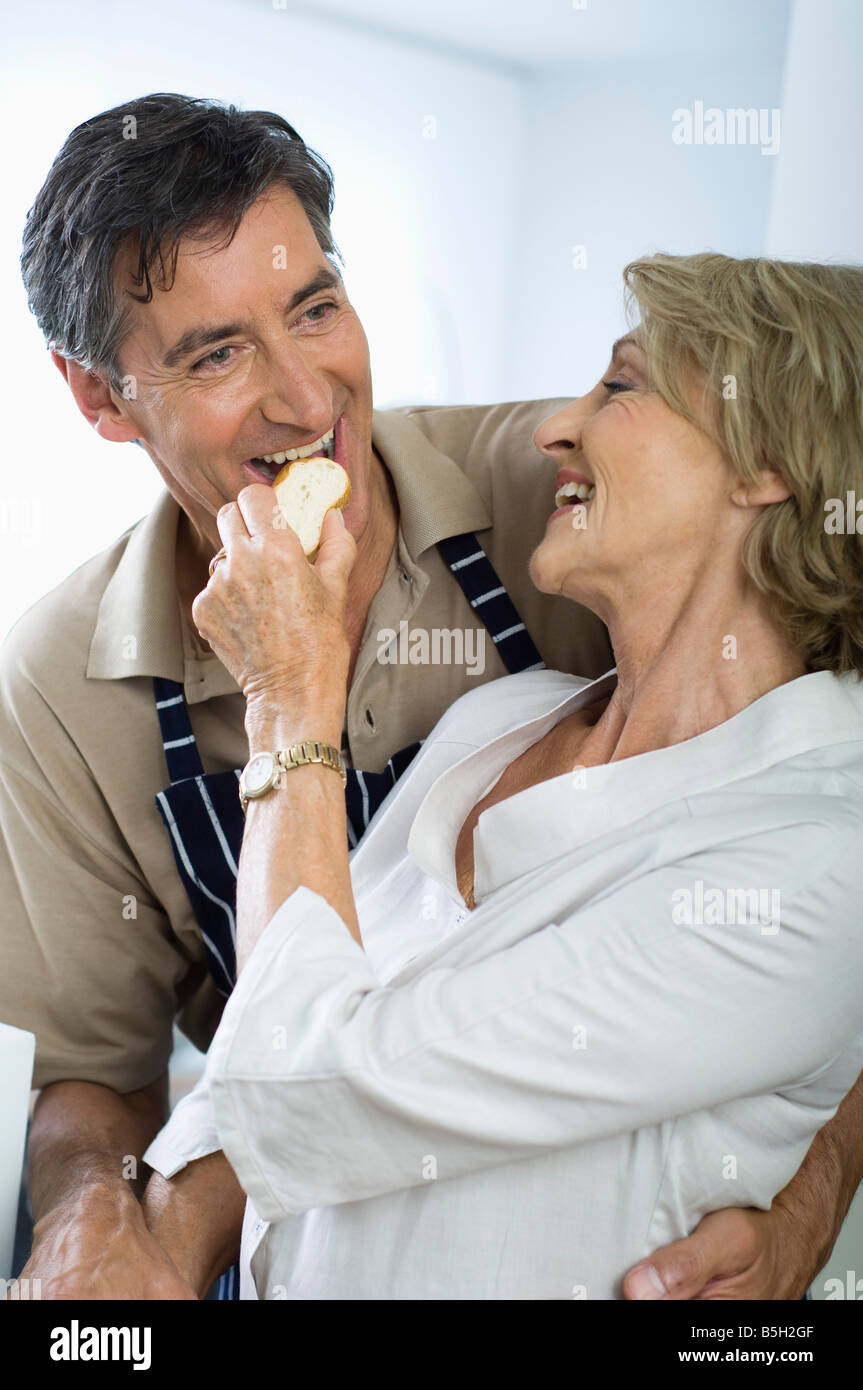 Woman feeding man with a slice of baguette Stock Photo - Alamy