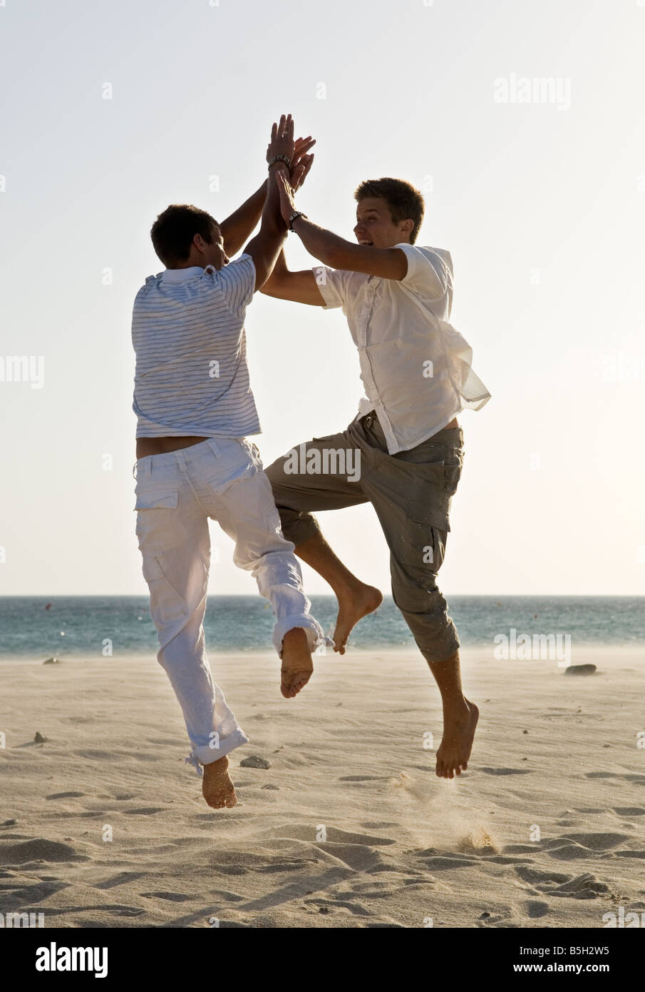 two men jumping at the same time Stock Photo - Alamy