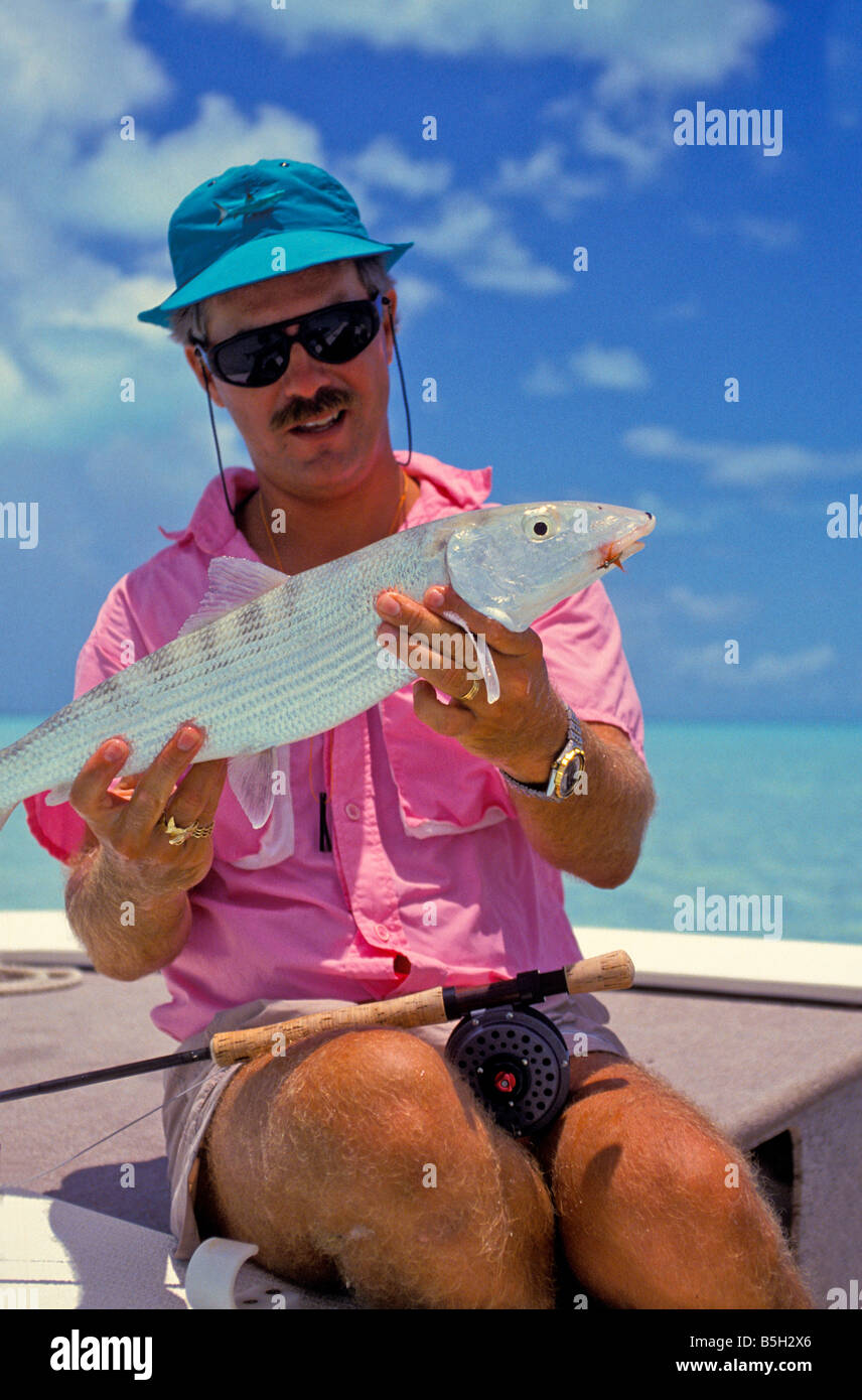 salt water fishing angler in flats fishing boat holds trophy bonefish ...
