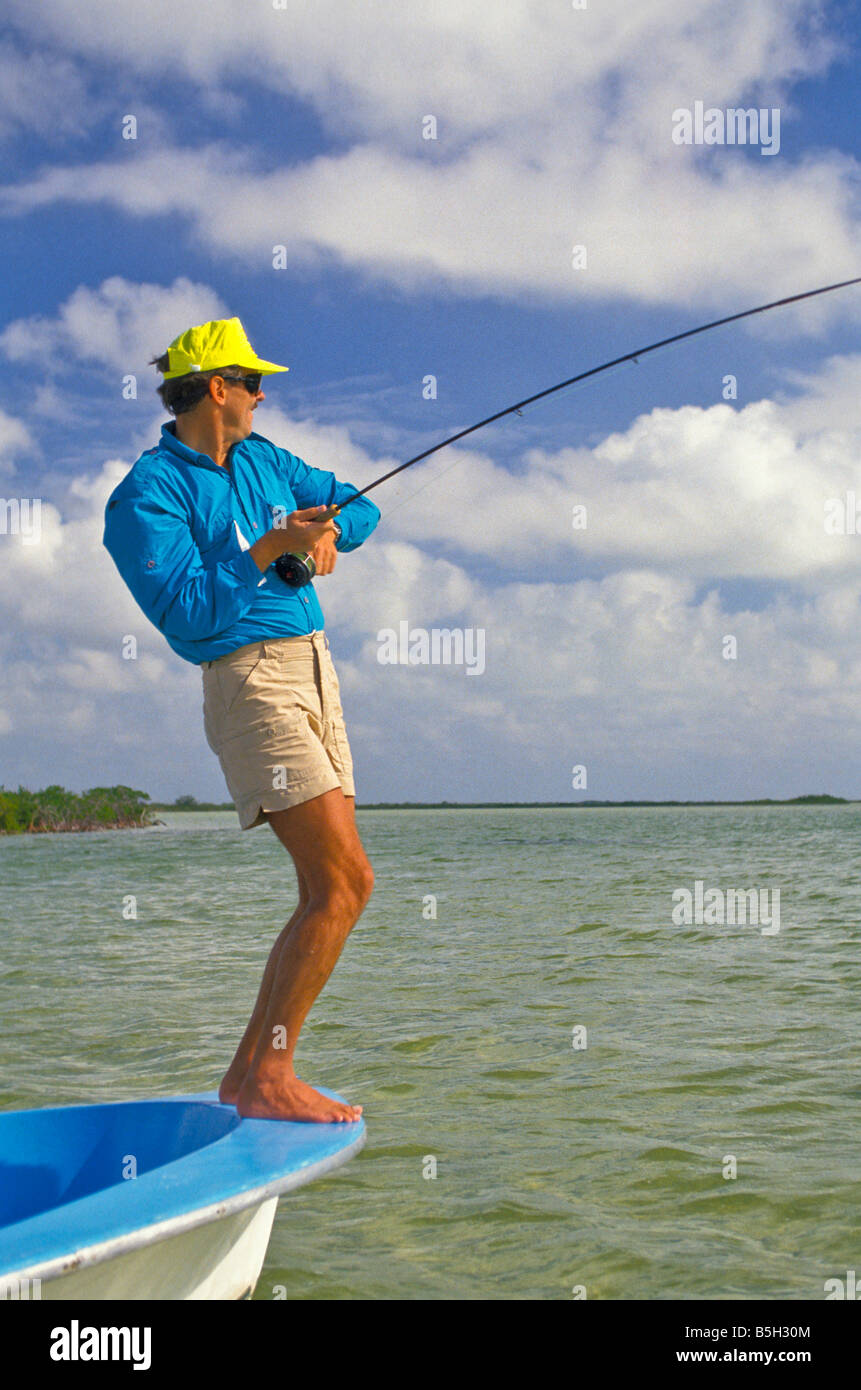 bonefishing angler fly rod bent standing boat bow Stock Photo - Alamy