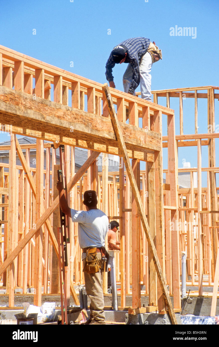 Homes being built in framing stage of construction Stock Photo - Alamy