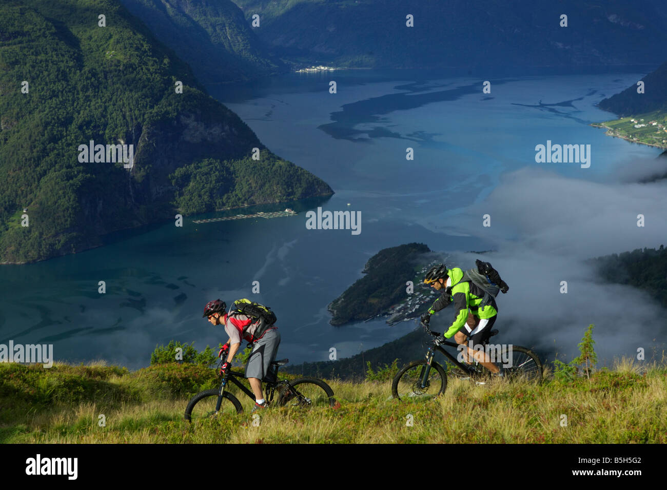 Mountainbike riders on a fjord Stock Photo - Alamy