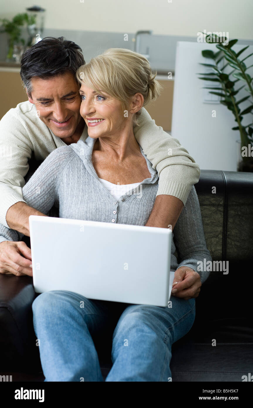 Couple using a laptop Stock Photo - Alamy