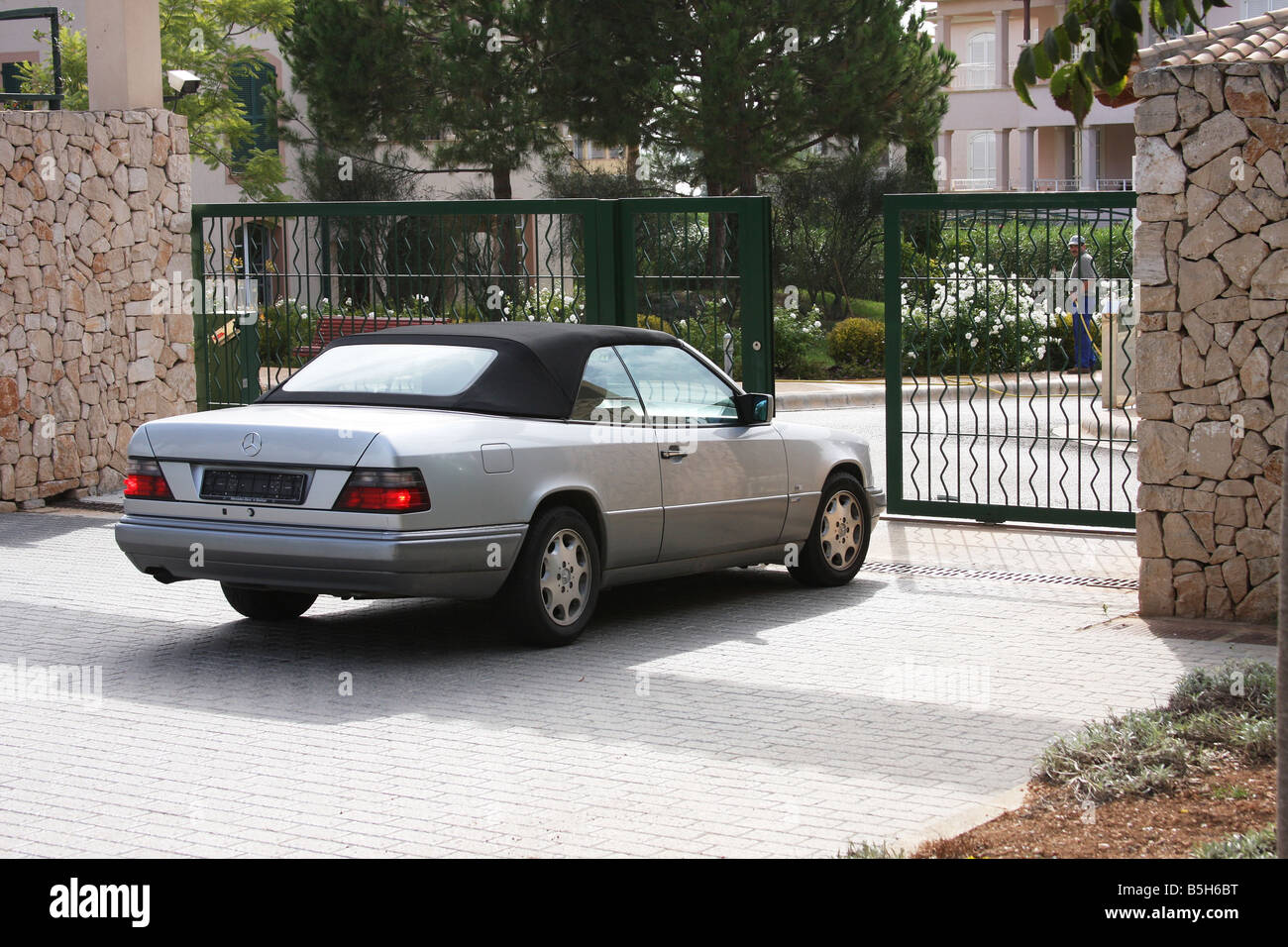 Car waiting to go through complex security gates which are opening ...