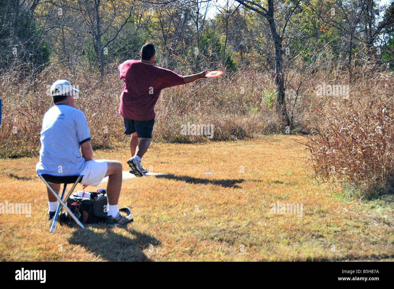 Two men play disc golf on a disc golf course. USA Stock Photo - Alamy