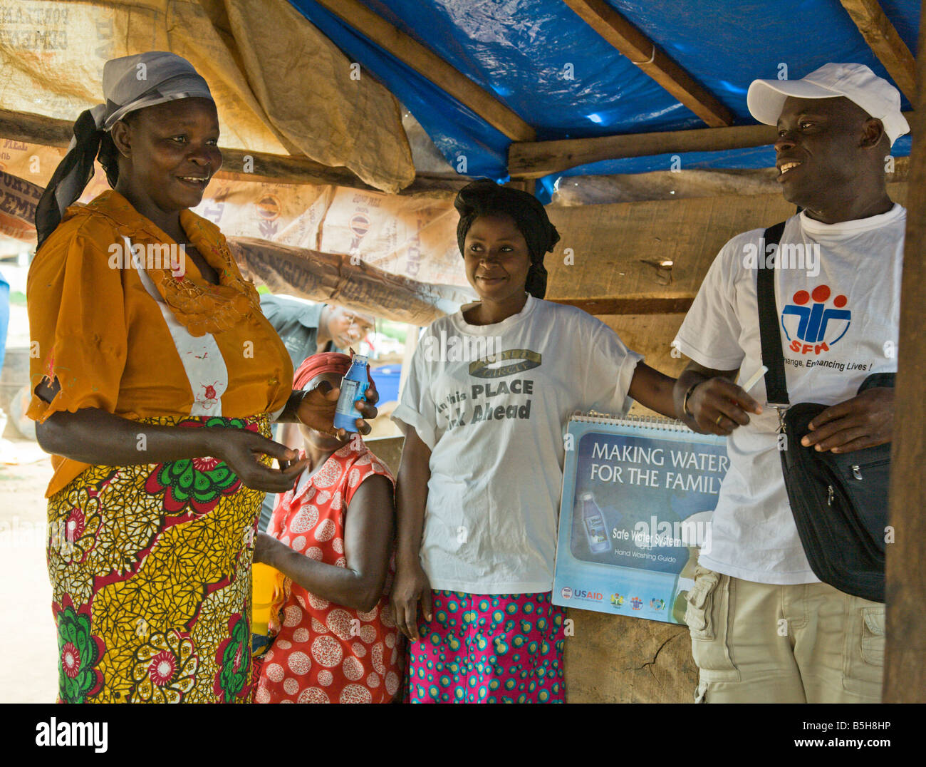 A woman in the crowd demonstrates how to use Waterguard to make water ...