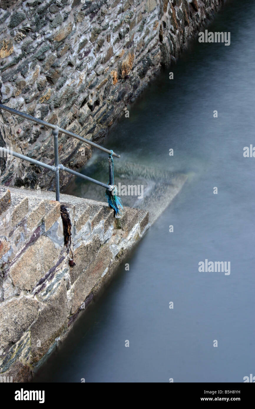 polperro harbour steps Stock Photo - Alamy