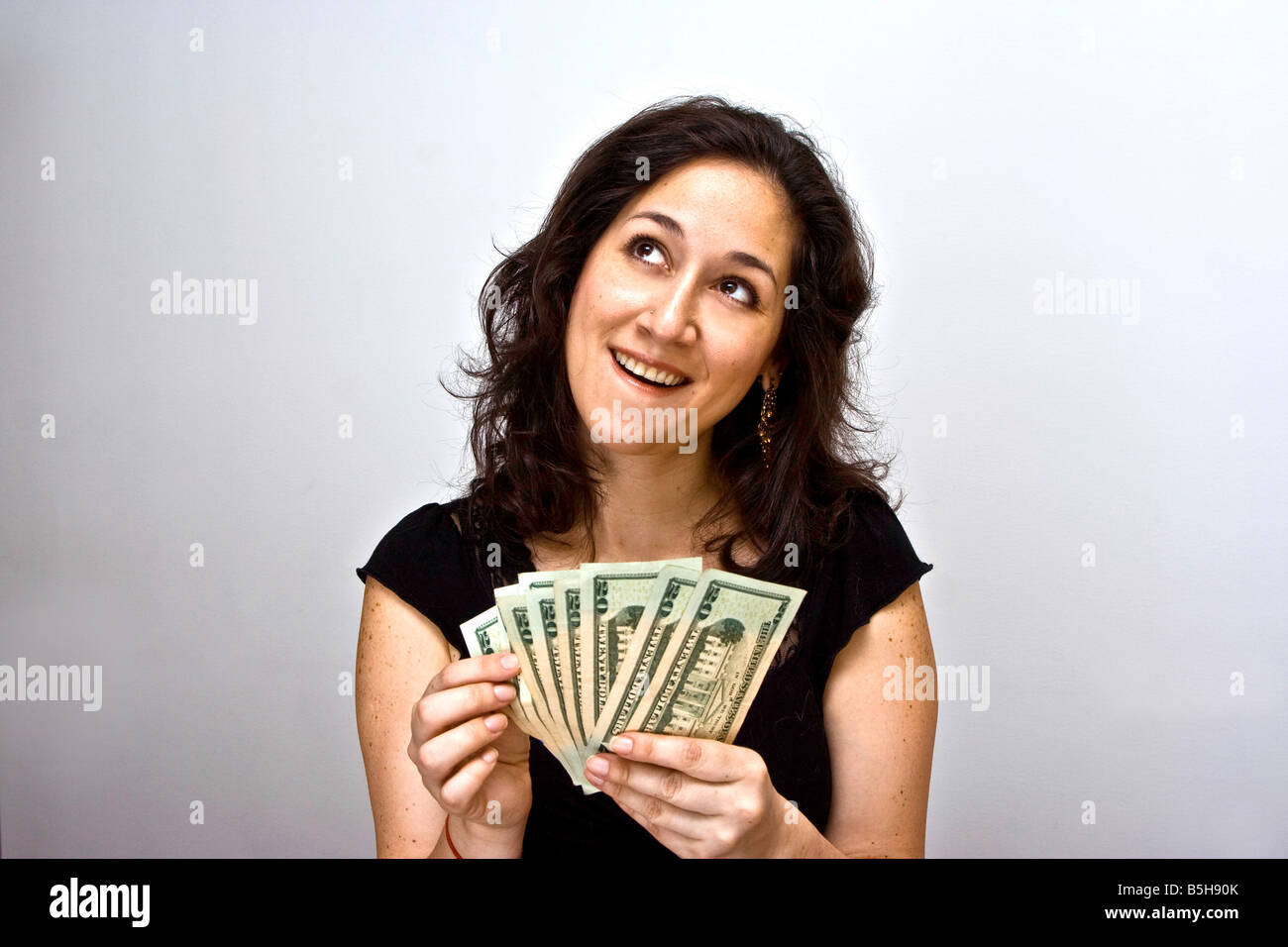 Women counting money and thinking what she can do with it Stock Photo ...