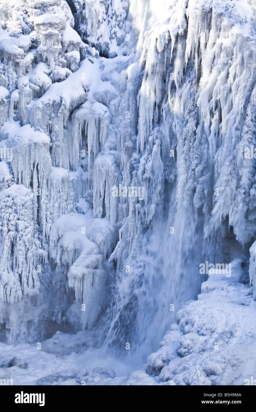 Freezing water rushes through a frozen waterfall Stock Photo - Alamy