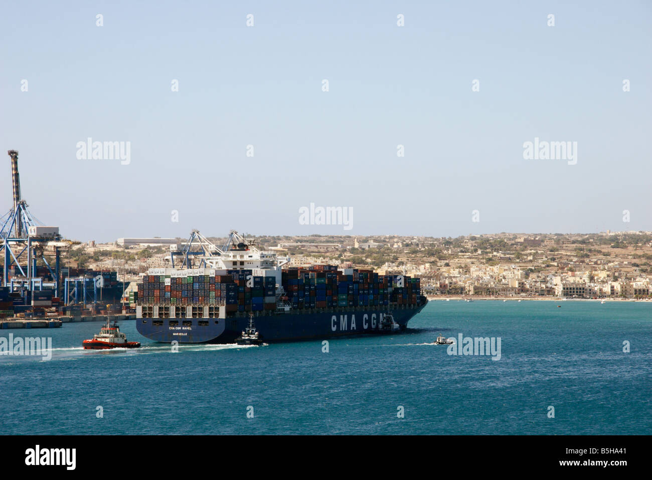 A container ship entering "Freeport Malta" docks in Malta Stock Photo ...