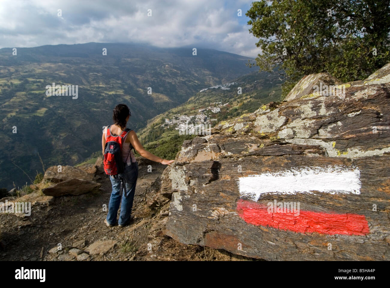 Trekker beside sign marking the Gran Recorrida GR 7 international ...