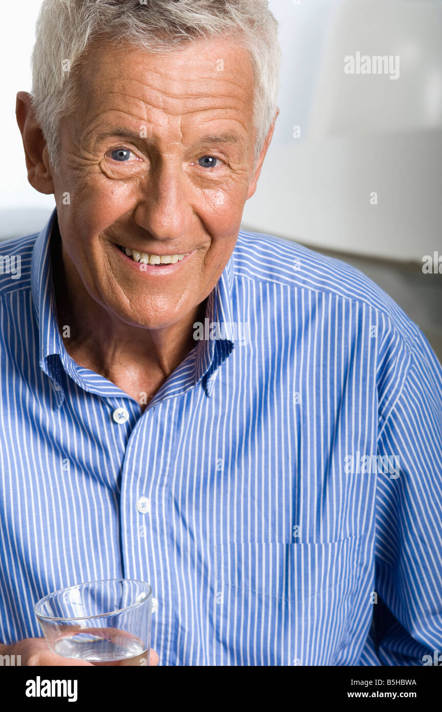 Senior man smiling at camera Stock Photo - Alamy