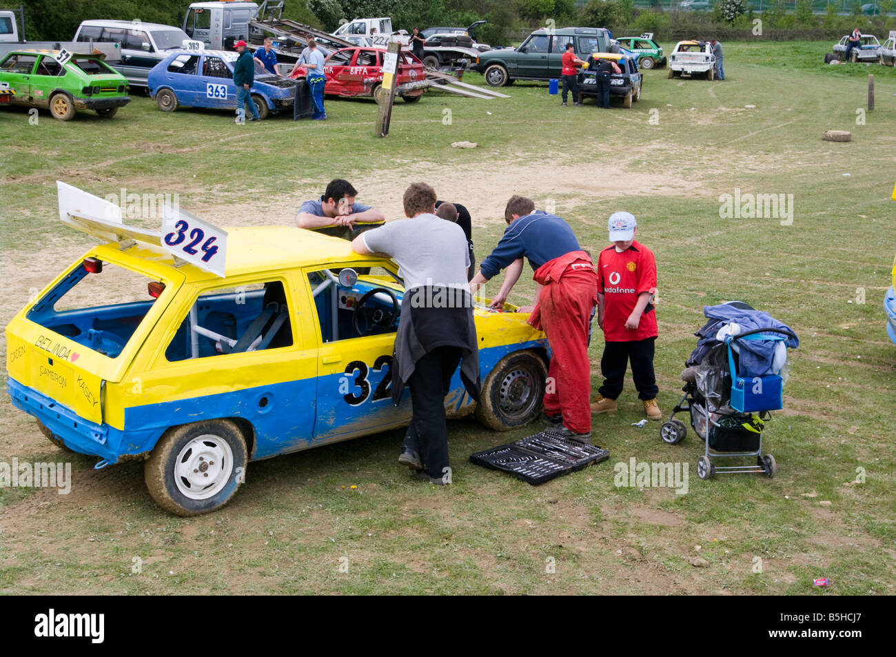 Mechanics Working on repairing mending a Banger Racing Car vehicle ...