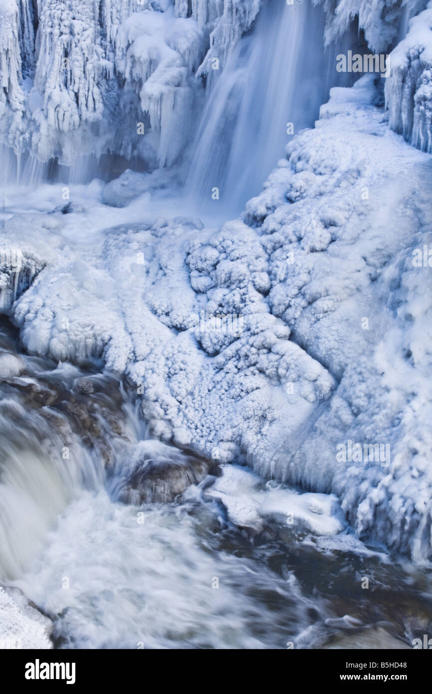 Freezing water rushes through a frozen waterfall Stock Photo - Alamy