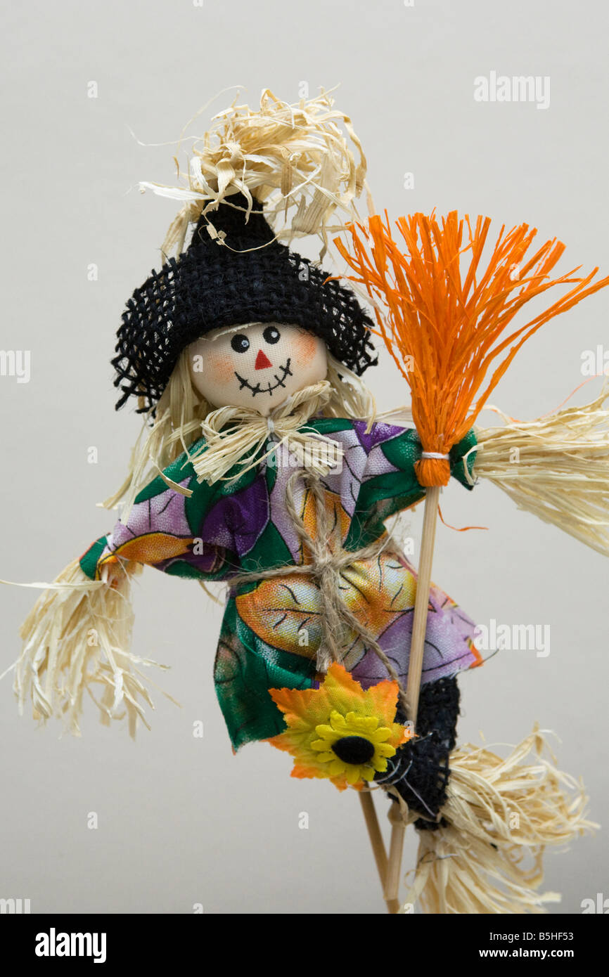 Charming Halloween straw witch doll with broomstick Stock Photo - Alamy