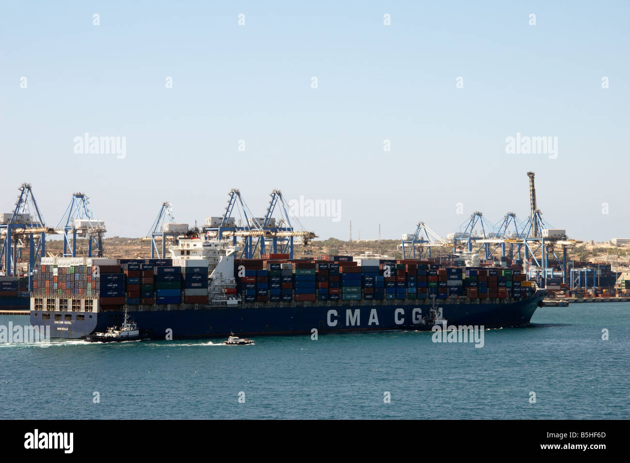 A container ship enters "Freeport Malta" docks in Malta Stock Photo - Alamy