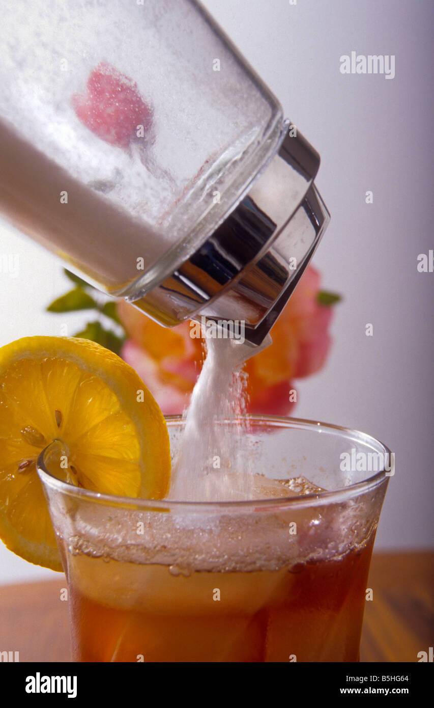 Sugar is poured into glass of iced tea Stock Photo - Alamy
