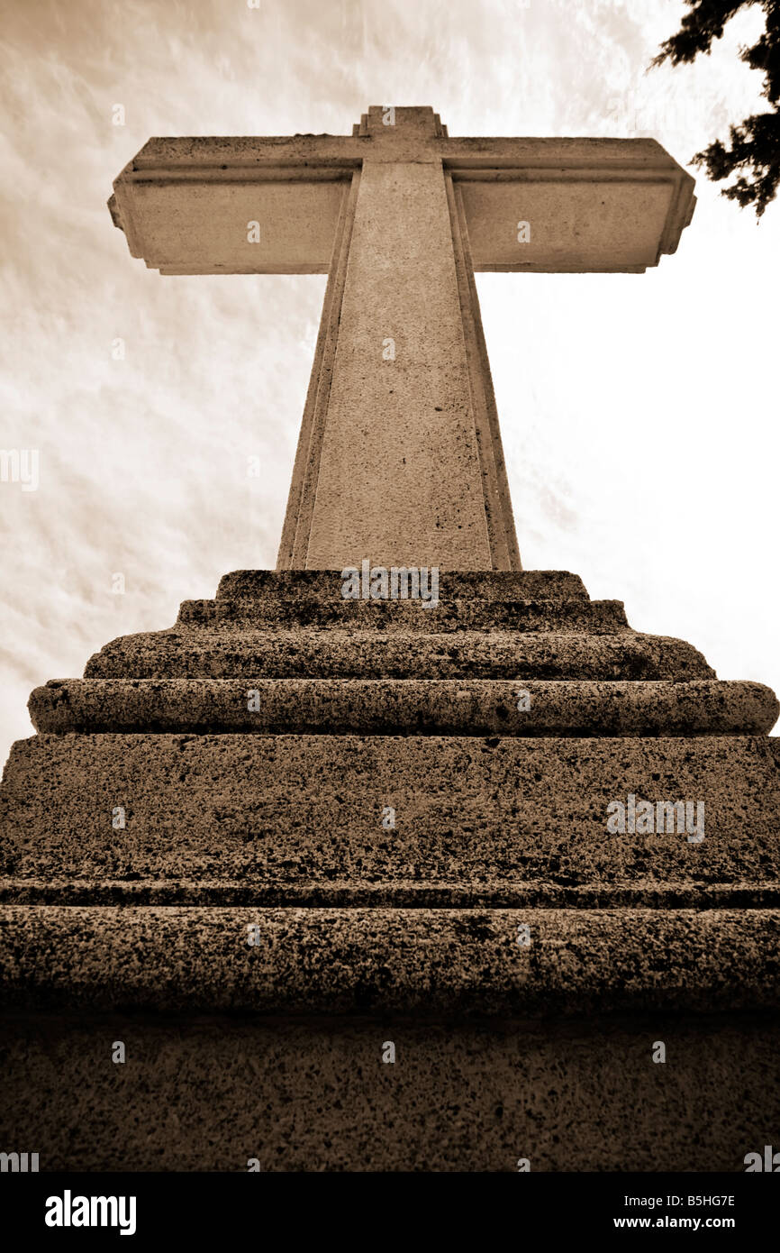 Christian stone cross under cloudscape sepia toned Stock Photo - Alamy