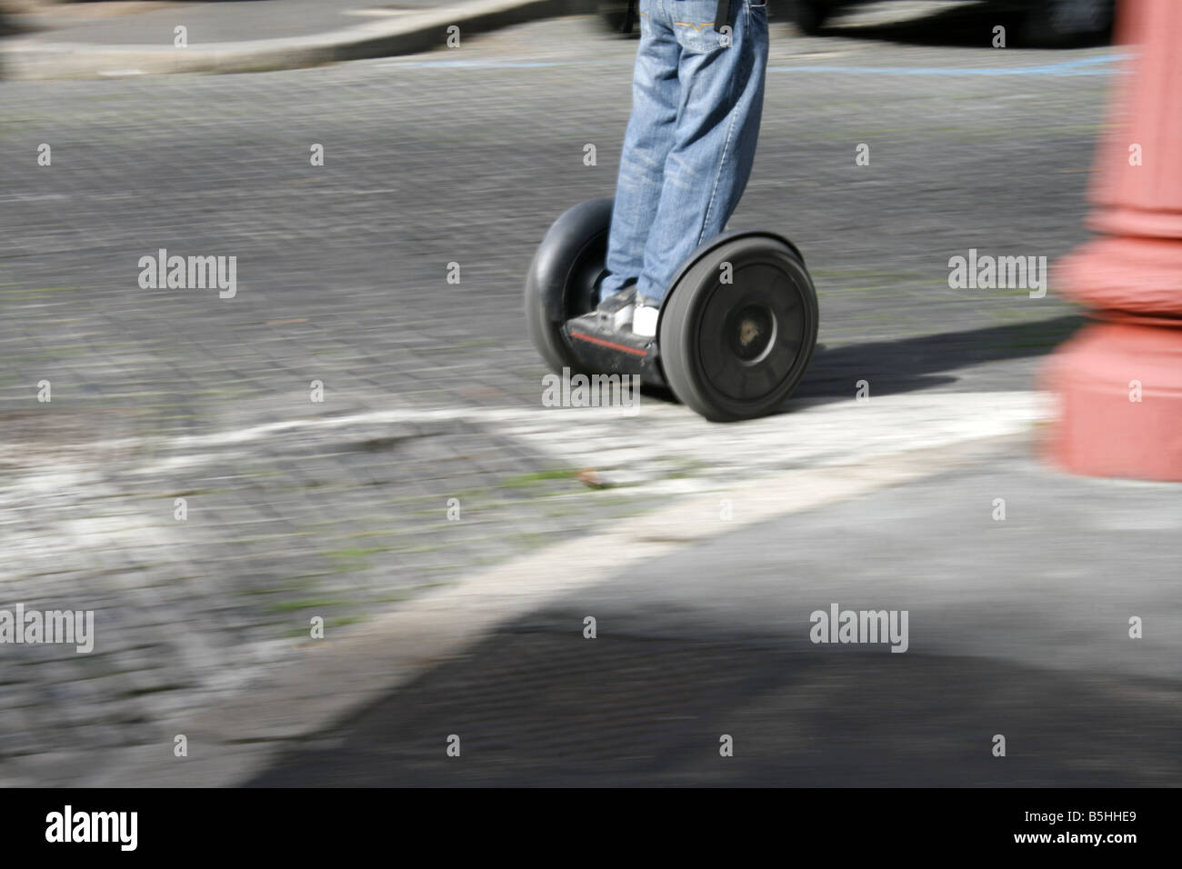 person riding segway personal transporter on street in town Stock Photo ...