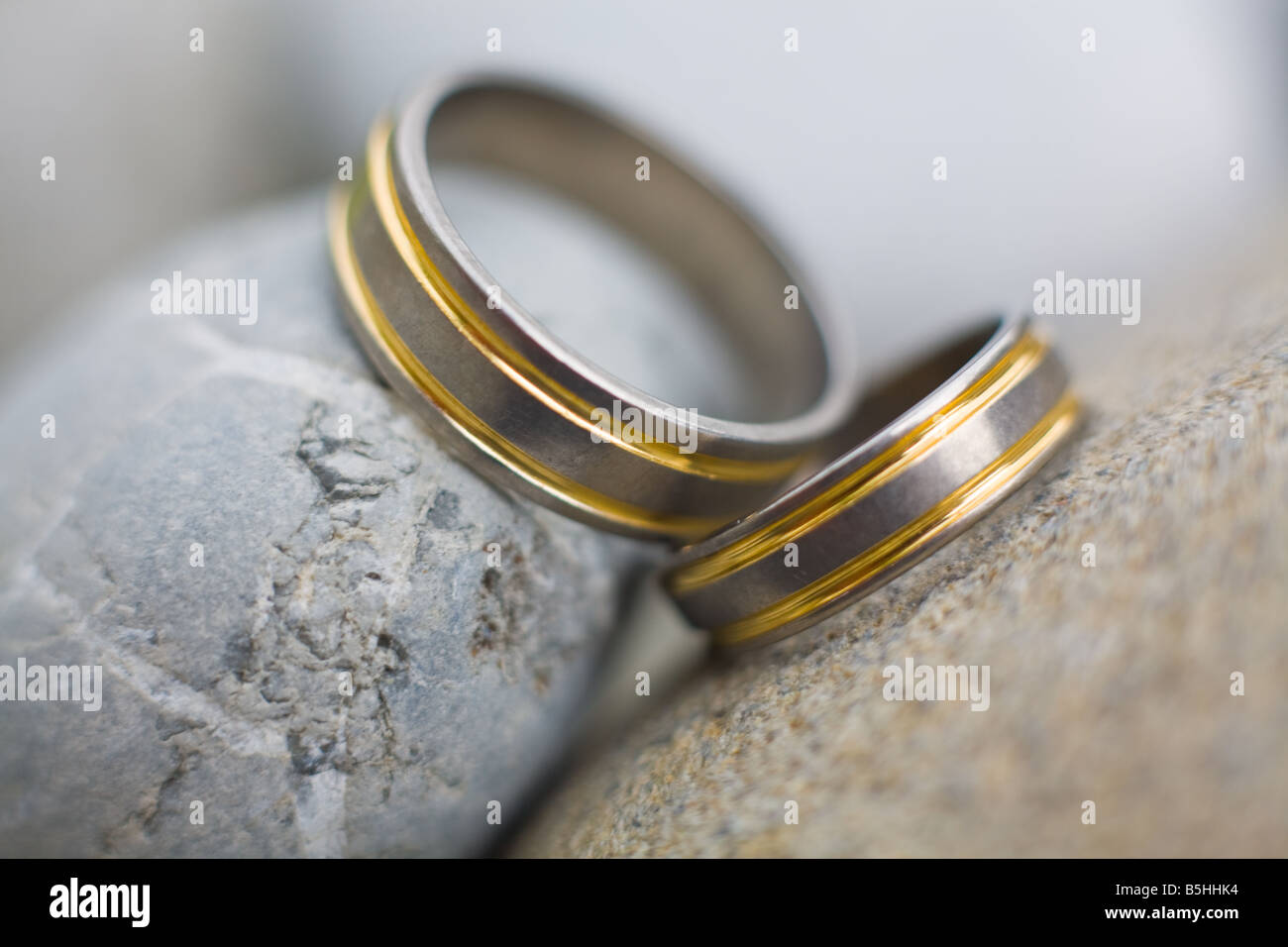 This stock photo depicts two wedding rings laying on rocks Stock Photo ...
