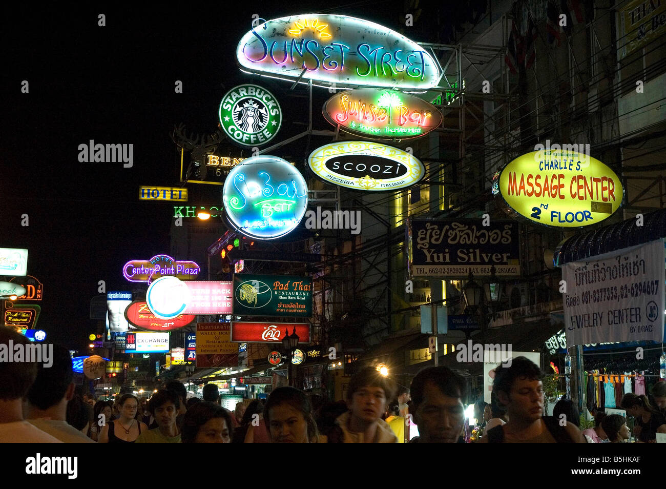 Commercial signs lit up at night in a market, Koh San Road, Bangkok ...