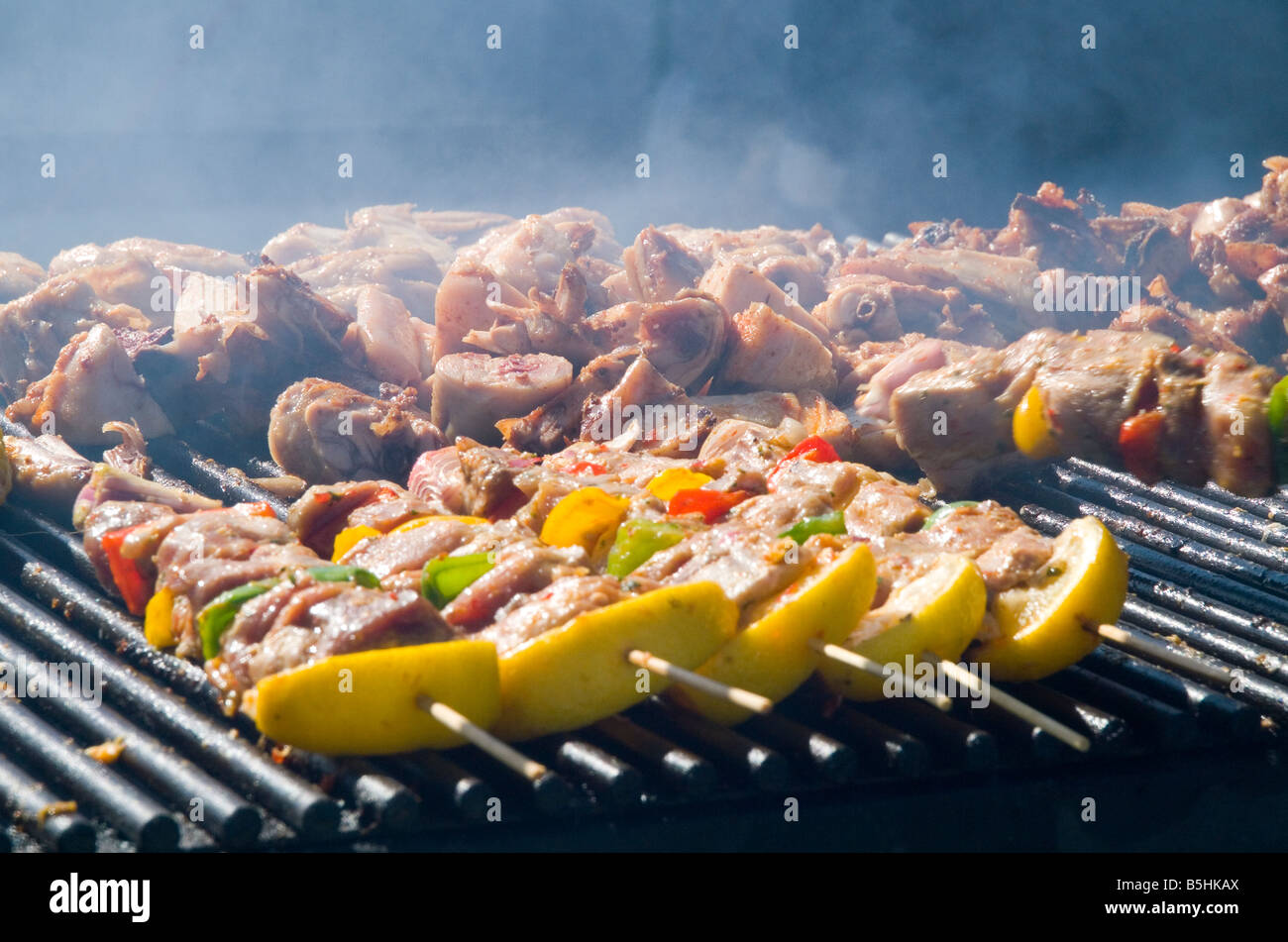 Close up of meat and kebabs cooking on a barbeque at the Caribbean ...