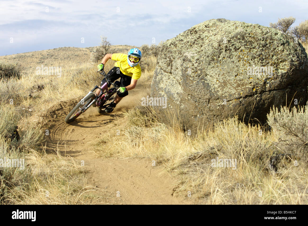 Downhill rider driving a tight turn Stock Photo - Alamy