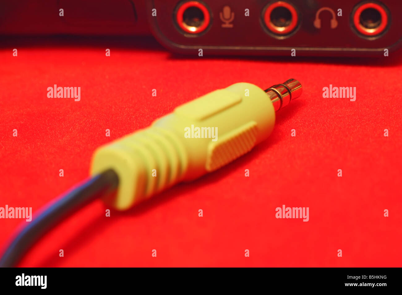 An audio connector against the audio ports of a notebook shallow depth ...