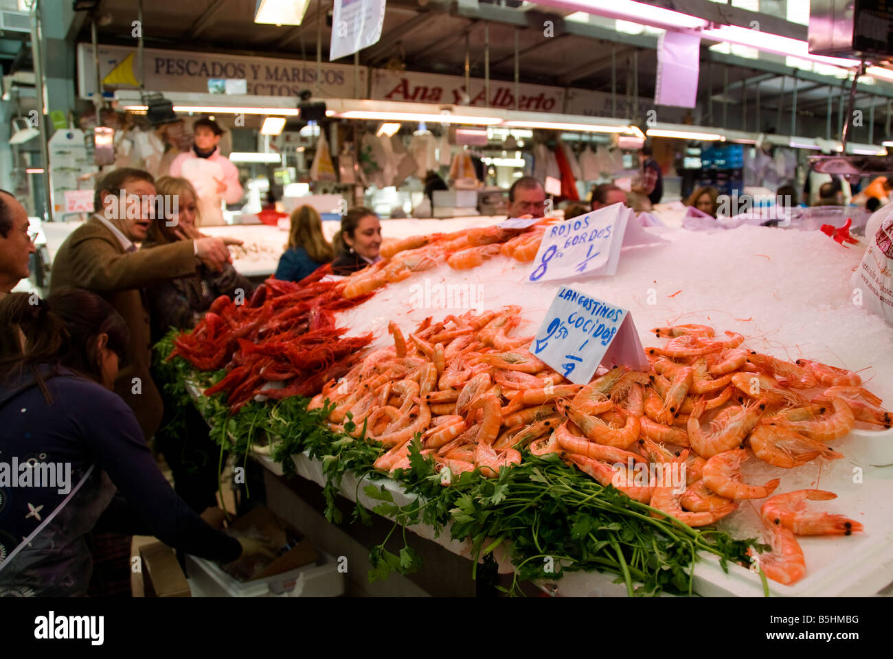 Spanish people buying langoustine in the central fish market Mercado ...