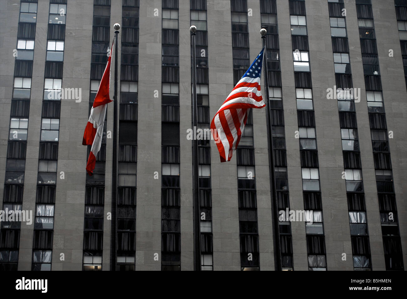 Two coloured flags in front of high rise building in New York Stock ...